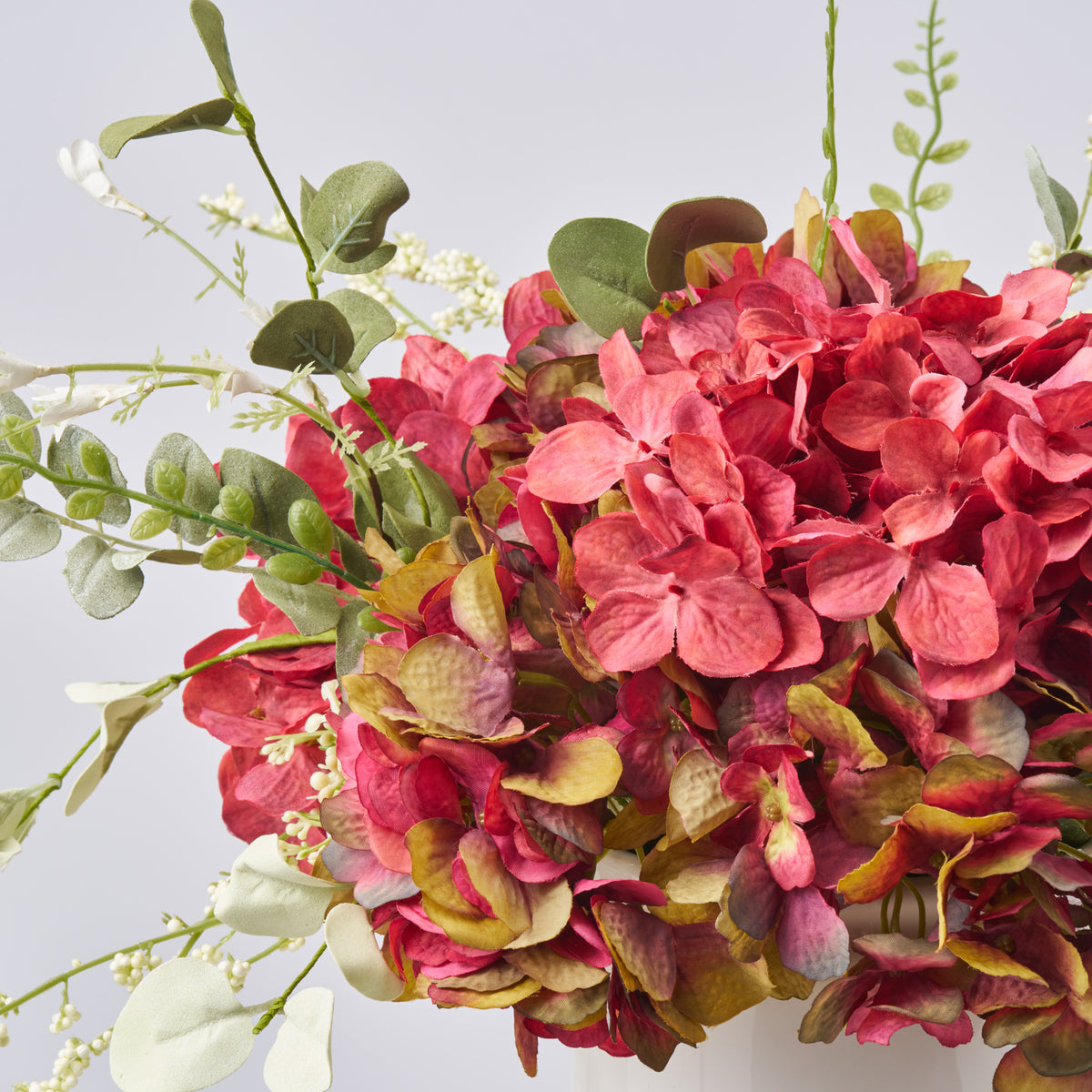 Mixed Mauve, Rosey Red Hydrangea Blooms & Ruscus in White Ceramic Vase ...